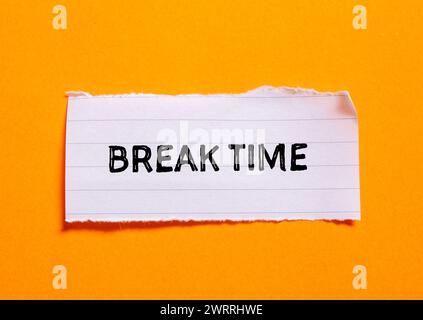 Break time words written on torn paper with purple background ...