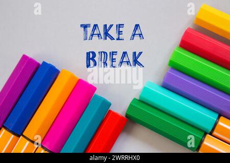 Take a break words written on torn paper piece with red background ...
