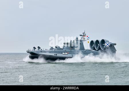 Hovercraft warship armed with armament sails into sea toward military ...