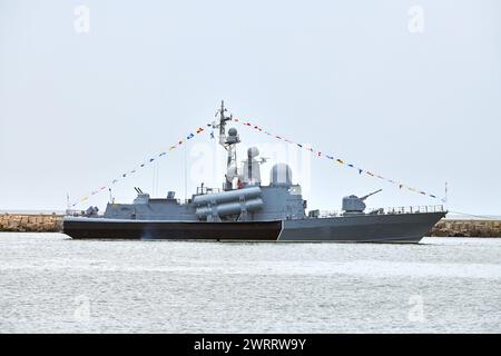 Russian naval ship with signal nautical flags anchored along shoreline ...