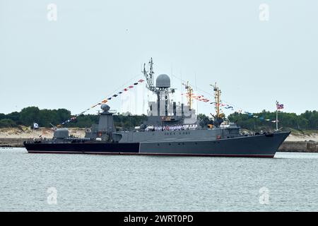 Russian naval ship with signal nautical flags anchored along shoreline ...