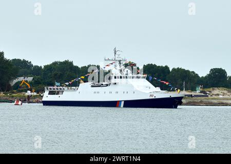 Russian naval ship with signal nautical flags anchored along shoreline ...
