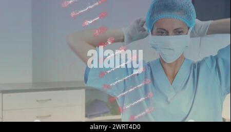 Image of caucasian female doctor with face mask over dna strand Stock ...