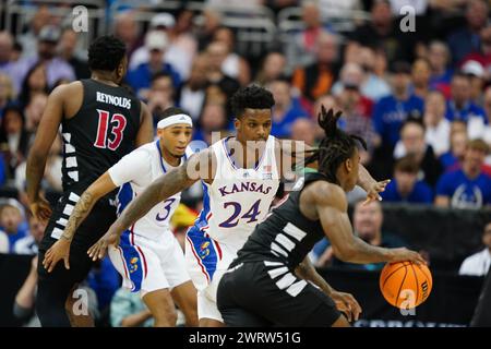 Cincinnati guard Jizzle James, center, defends as Oklahoma guard Milos ...