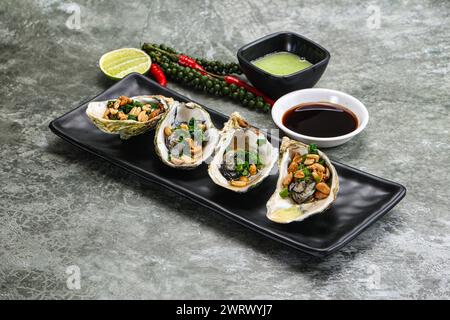 Open half oysters with green onion and peanut Stock Photo - Alamy