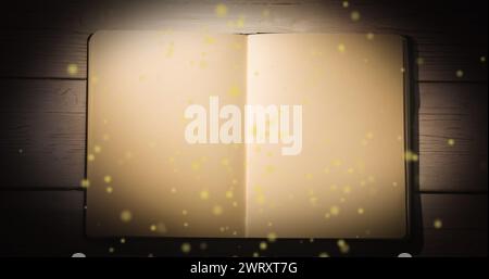 Image of yellow glowing spots over open book Stock Photo - Alamy