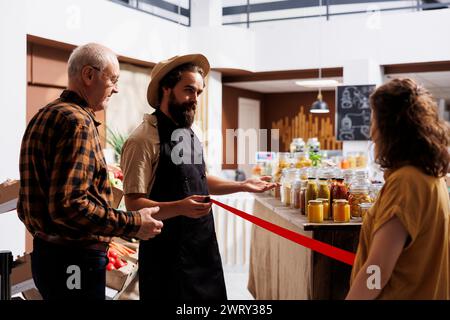 Newly opened zero waste shop owner inviting clients in after preparing ...
