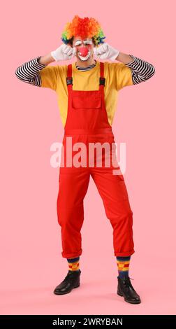 Portrait of sad clown on pink background. April Fool's day celebration ...