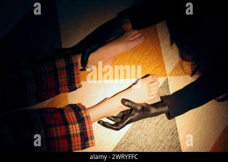 Scary monster under bed grabbing little girl by legs, closeup Stock ...