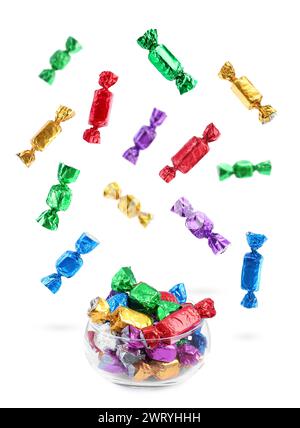 Tasty candies in bright wrappers falling on white background Stock ...