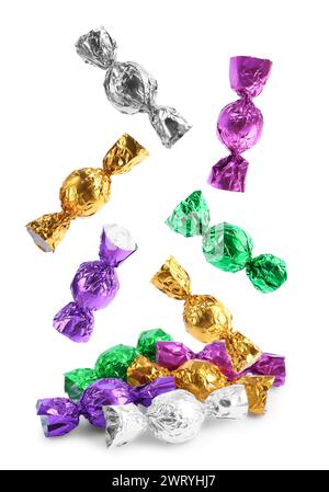 Tasty candies in bright wrappers falling on white background Stock ...