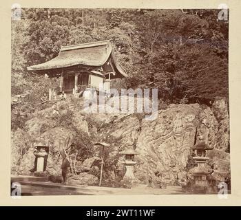 View of lanterns on rocks in the sea at a shrine, Yaotomi Shrine ...