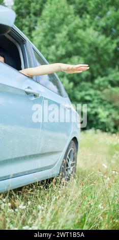 Hand reaching out from a car window enjoying the forest view Stock ...