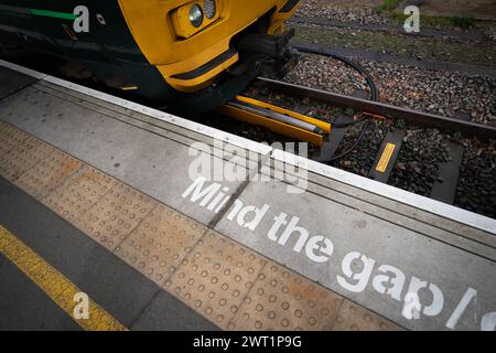 A train approaches charging rails at West Ealing Station, London ...