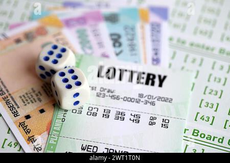 Green lottery tickets and indian rupees money bills on blank with ...