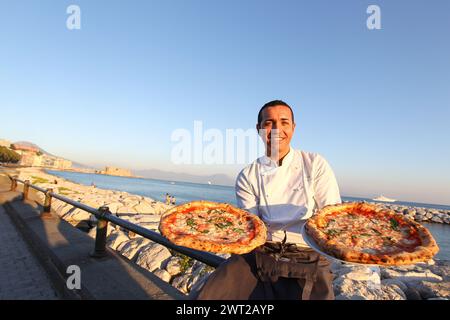 The pizza master, Gino Sorbillo, shows the freshly baked pizzas on the ...