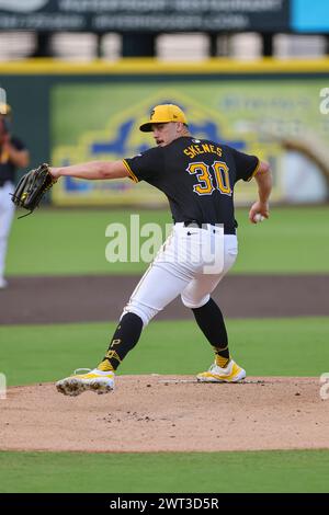 Pittsburgh Pirates starting pitcher Paul Skenes looks down at the ball ...