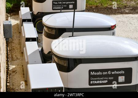 Delivery robots at charging point Stock Photo - Alamy