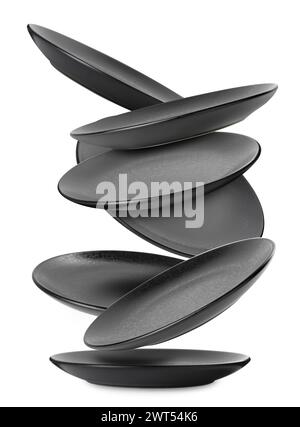 Clean ceramic plates falling on white background Stock Photo - Alamy