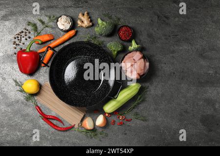 Empty iron wok surrounded by raw ingredients on light table, flat lay ...