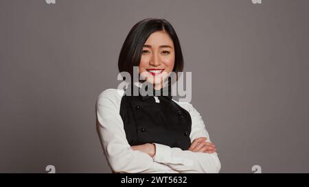 Asian diner employee prepared to serve food at tables, working in ...