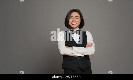 Asian woman hotel concierge wearing elegant uniform with bow, working ...