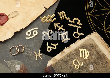 Flat lay composition with zodiac signs on grey textured table. Space ...