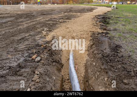 Construction photo of natural turf athletic field vertical edge drain ...