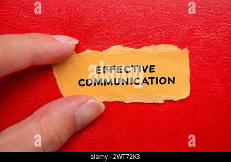Effective communication words written on blue torn paper with pink ...