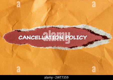 Cancellation policy words written on torn paper piece with blue ...