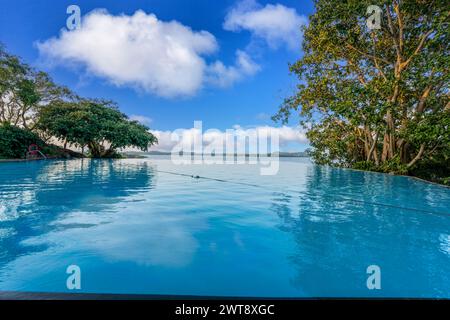 A tranquil infinity pool at Heritance Kandalama, Sri Lanka, under a ...