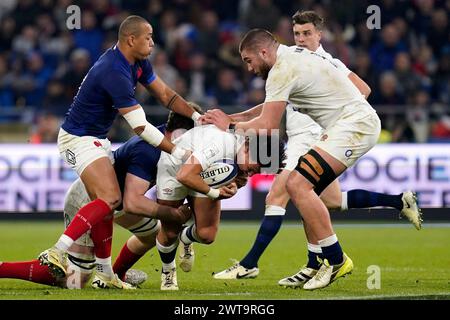England's Marcus Smith (centre) is tackled by New Zealand's Billy ...