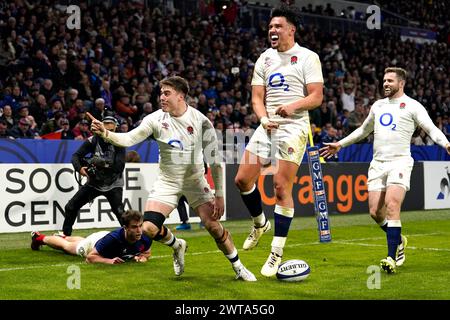 England's Tommy Freeman celebrates scoring their side's third try of ...