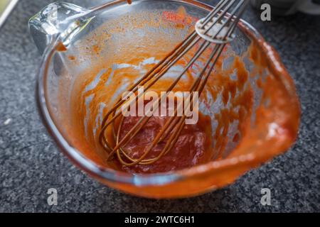 Used filthy measure jar with red sauce leftovers Stock Photo - Alamy