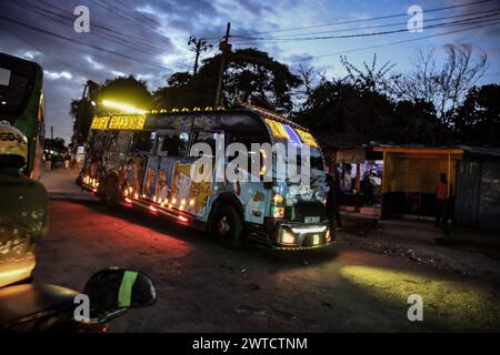 Commuters buses drive through the busy roads in Kibera Slum during ...