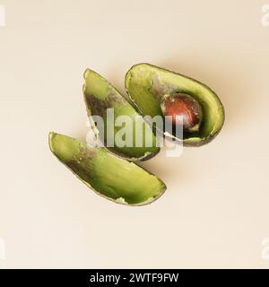 Emptied shell of an avocado and seed avocado with copy space on beige ...
