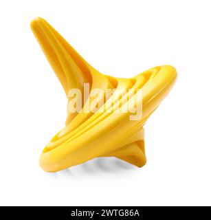 One yellow spinning top on white background Stock Photo - Alamy