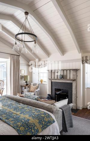 Glass pendant light hangs from architectural ceiling in luxury hotel in ...