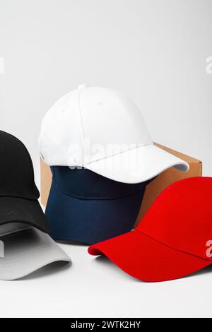 Light blue baseball cap and stack of folded t-shirts isolated on white ...