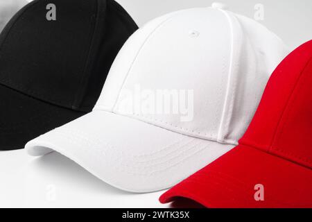 Lineup of Four Blank Baseball Caps in Red, White, and Black on a White ...