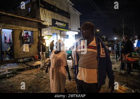 Residents walk back home late in the evening past the busy streets in ...