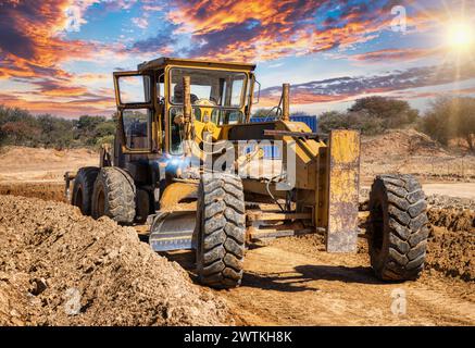 yellow grader digging the earth on a construction site at a diamond ...