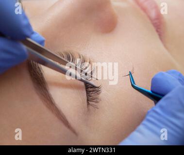 Eyelash removal procedure close up. Beautiful Woman with long lashes in ...