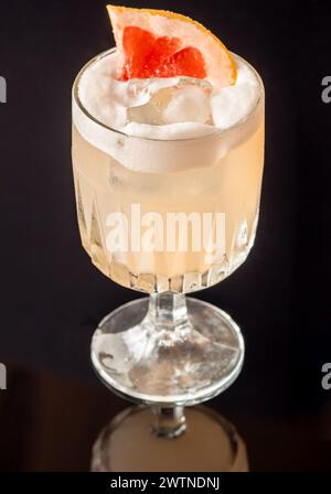 Goblet glass of Grapefruit tequila sour cocktail Stock Photo - Alamy