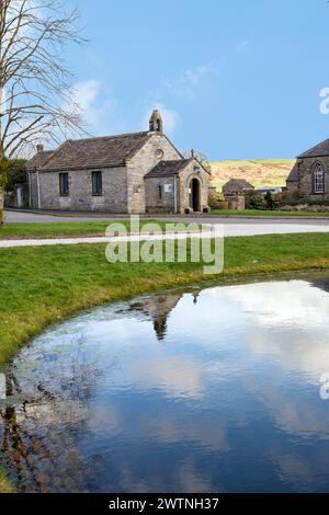 St Hugh's Church parish church seen across the village pond in the ...