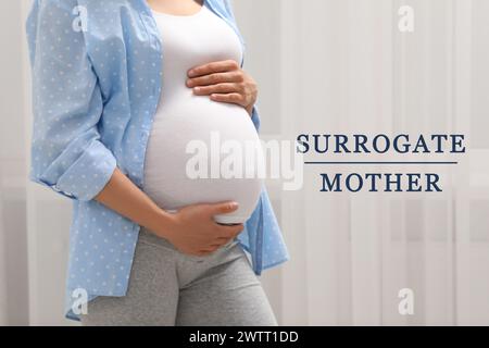 Surrogate mother. Pregnant woman touching her belly on beige background ...