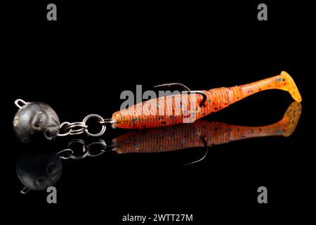 Orange fishing lure, plastic shad fish, with double hook and lead ...