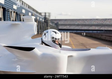 Race car driver focused and ready behind the wheel Stock Photo - Alamy