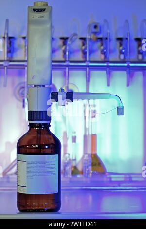 Chemical lab glassware: burette over beaker, Erlenmeyer flask with ...