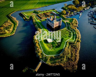 Aerial view of a historic castle surrounded by a forest, with vast ...